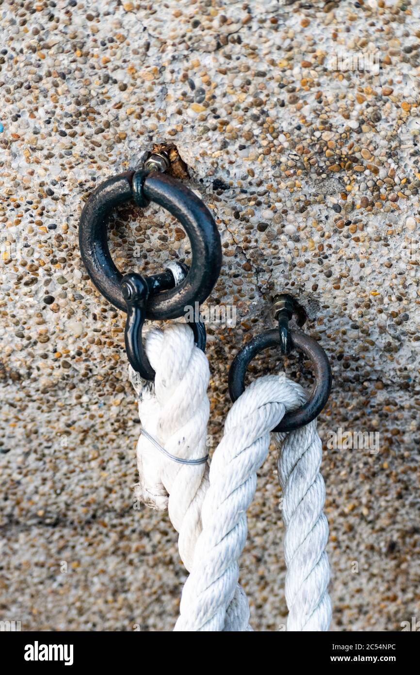 Vertical closeup shot of steel rings with white ropes Stock Photo - Alamy