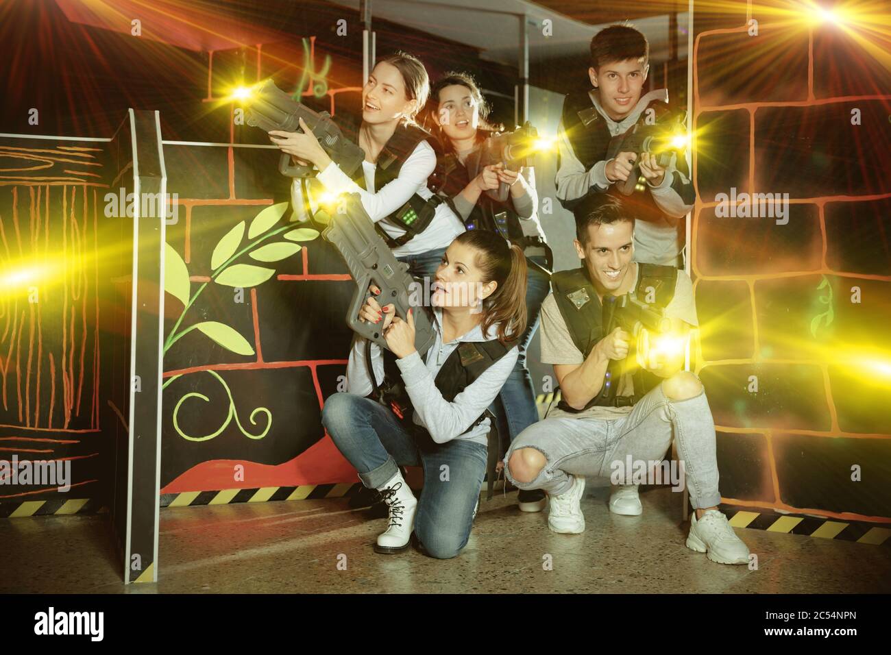 Group glad people playing laser tag game Stock Photo - Alamy