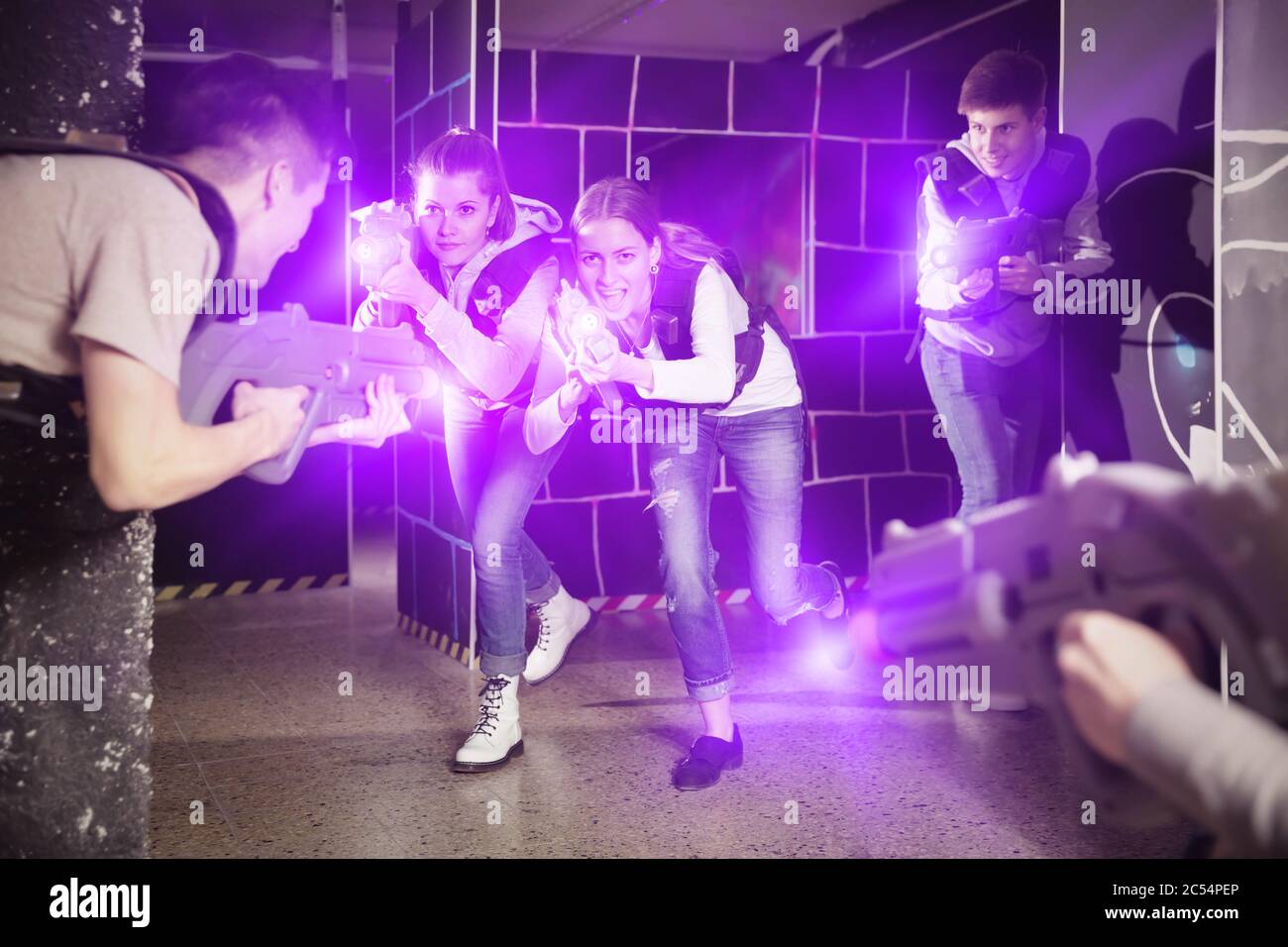 Women with laser gun having fun on dark lasertag arena Stock Photo - Alamy