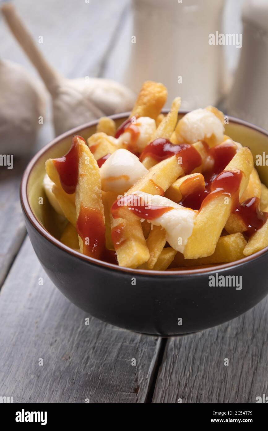 Canadian poutine, fried potato chips with cheese and gravy or sauce ...