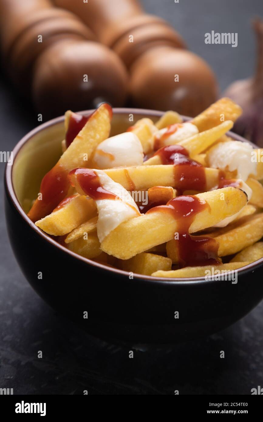 Canadian poutine, fried potato chips with cheese and gravy or sauce ...