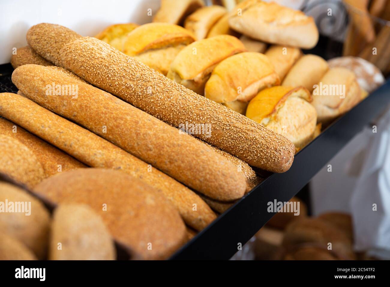 Delicious and fresh bread products lying on counter in bakery Stock ...