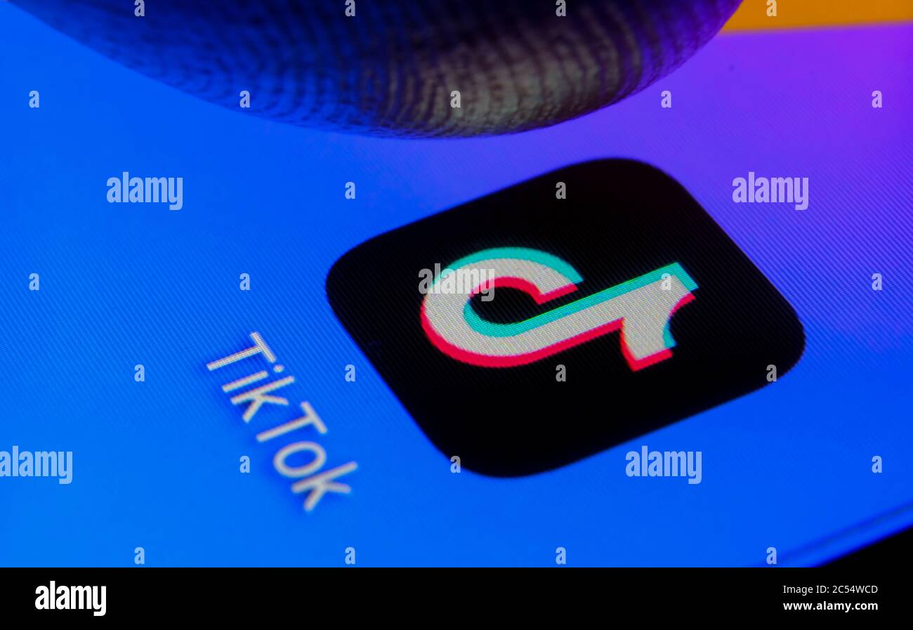 Finger pointing at TikTok app on the smartphone screen. Macro Stock ...