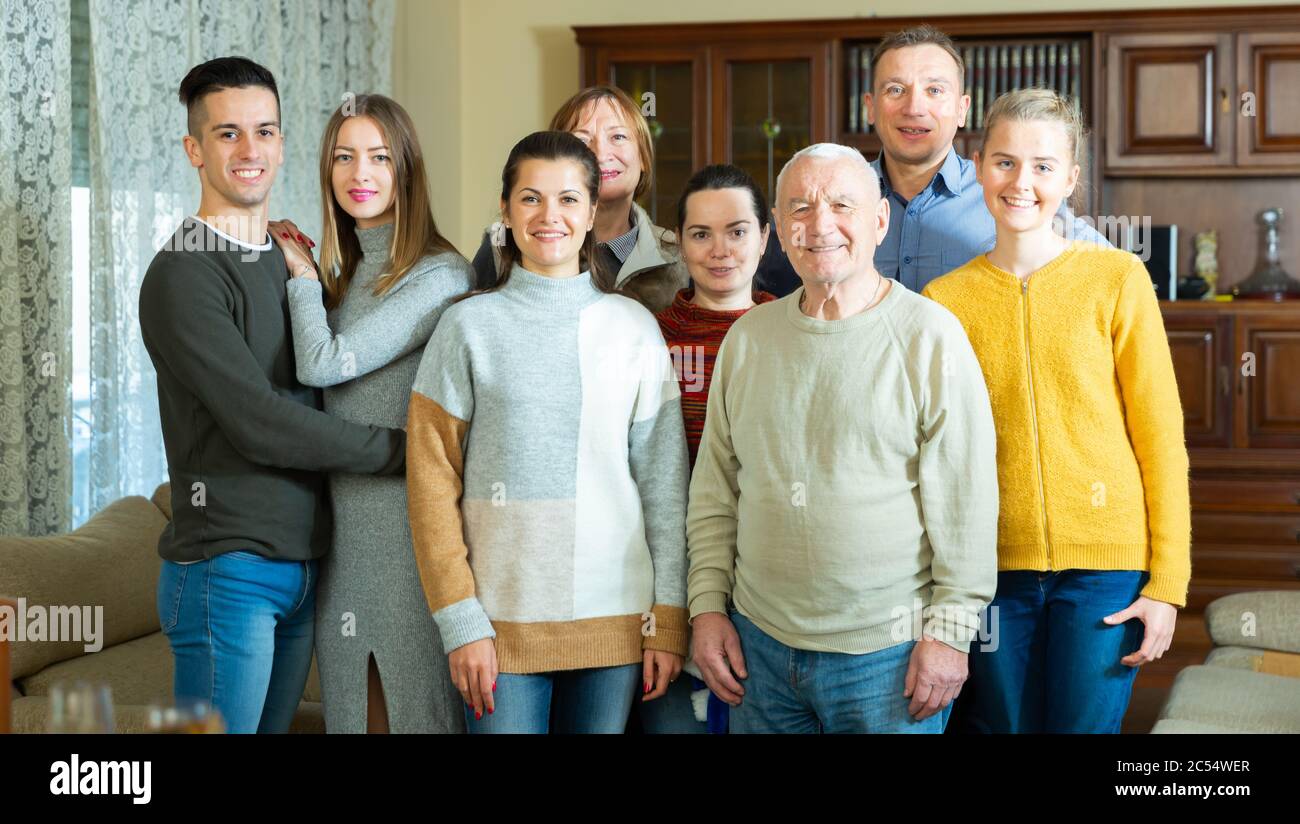 Portrait of happy family with grandparents and children posing at home ...