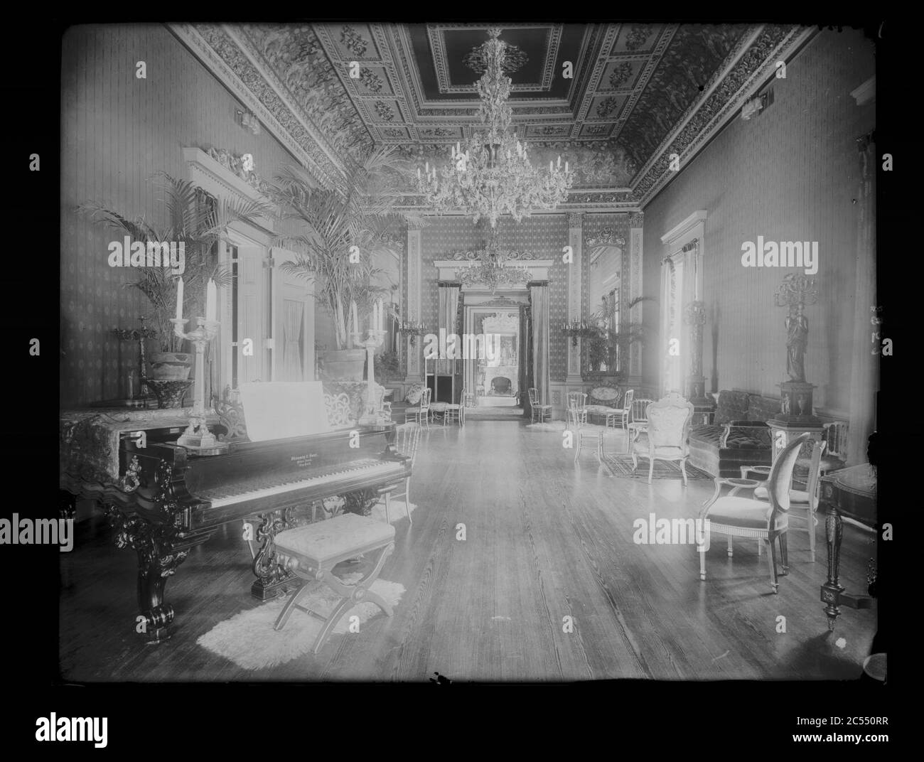 Interior view of a large hall with piano, chairs, small tables, and ...