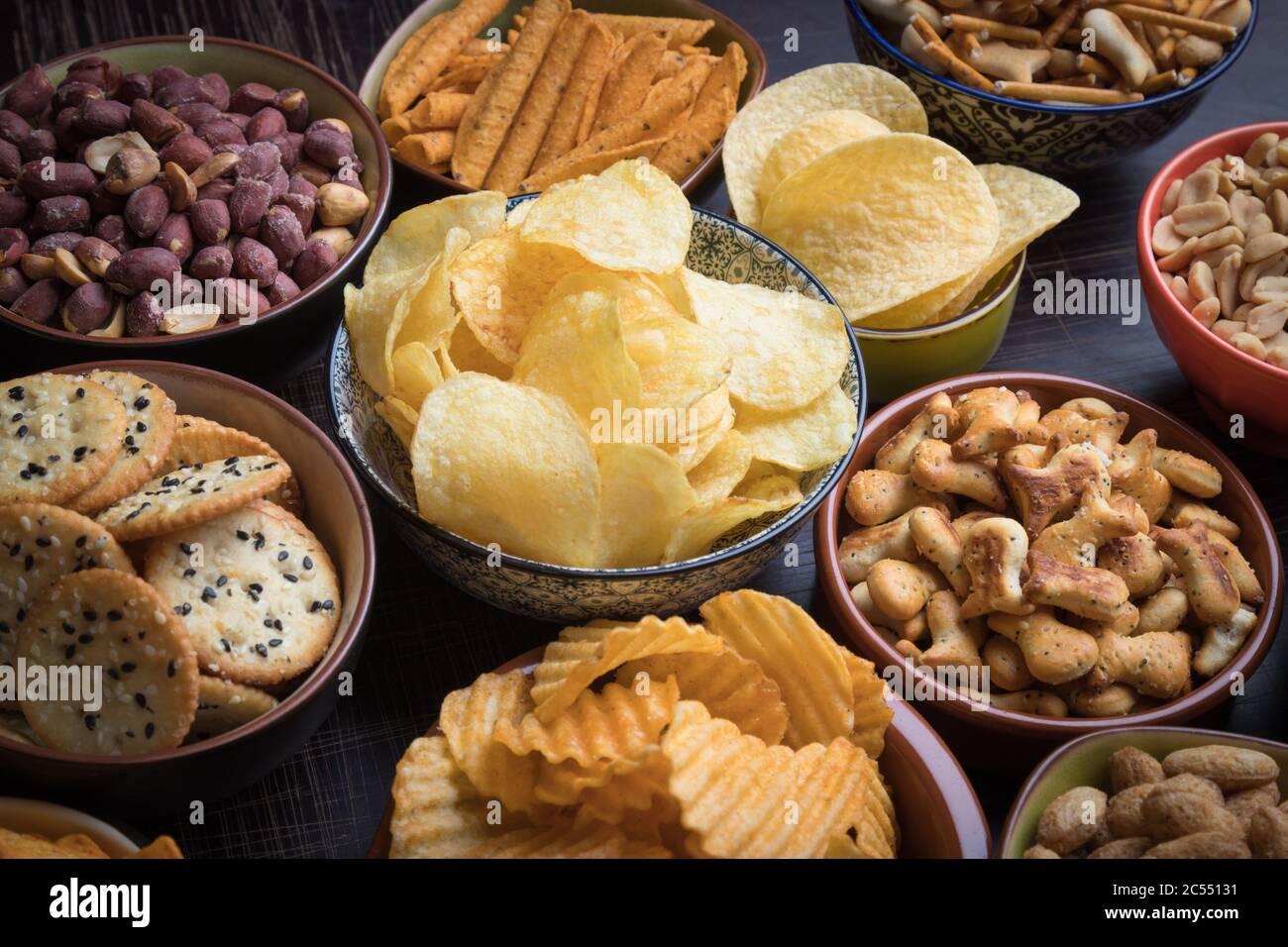 Salty snacks served as party food in ceramic bowls Stock Photo - Alamy
