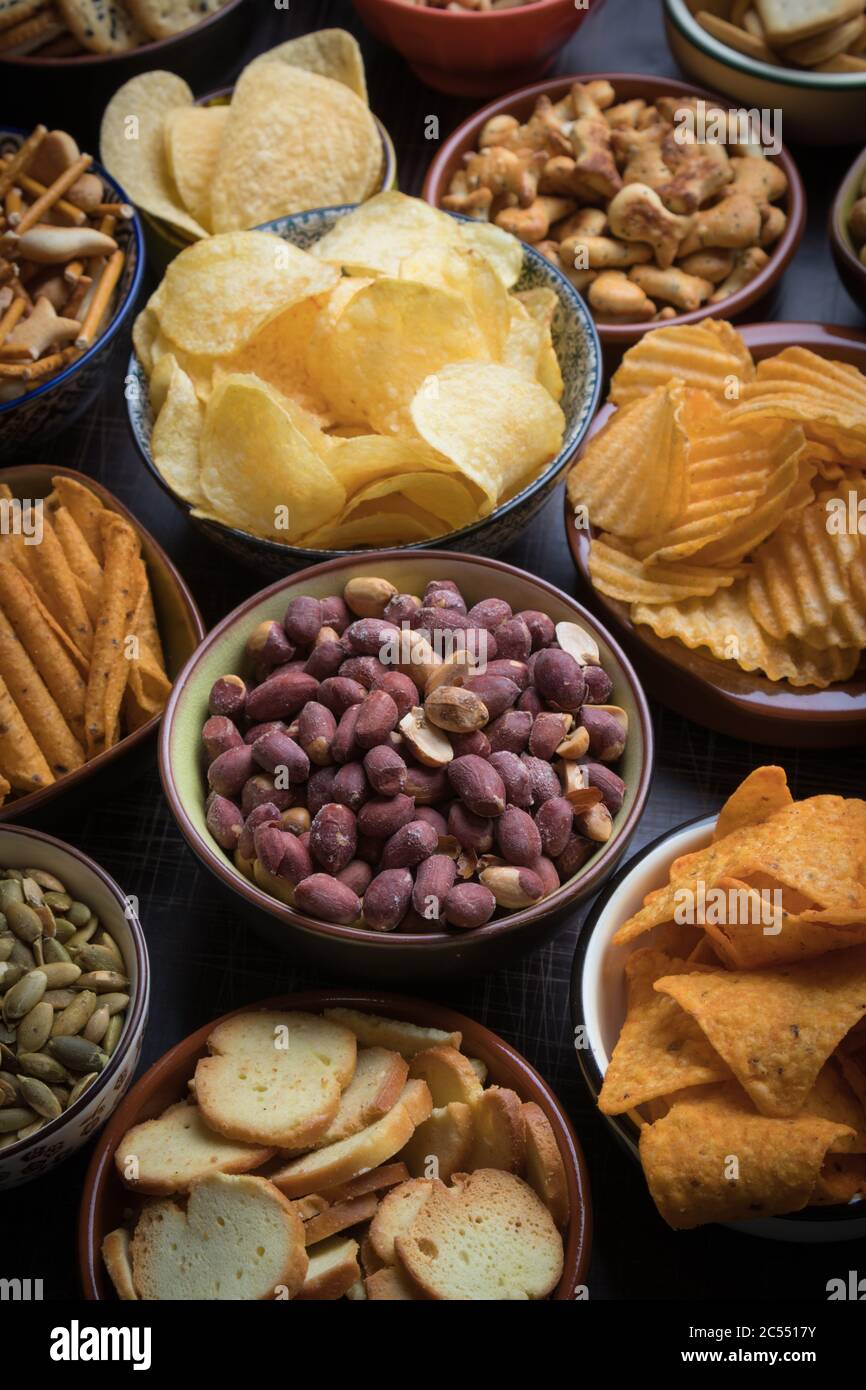 Salty snacks served as party food in ceramic bowls Stock Photo - Alamy