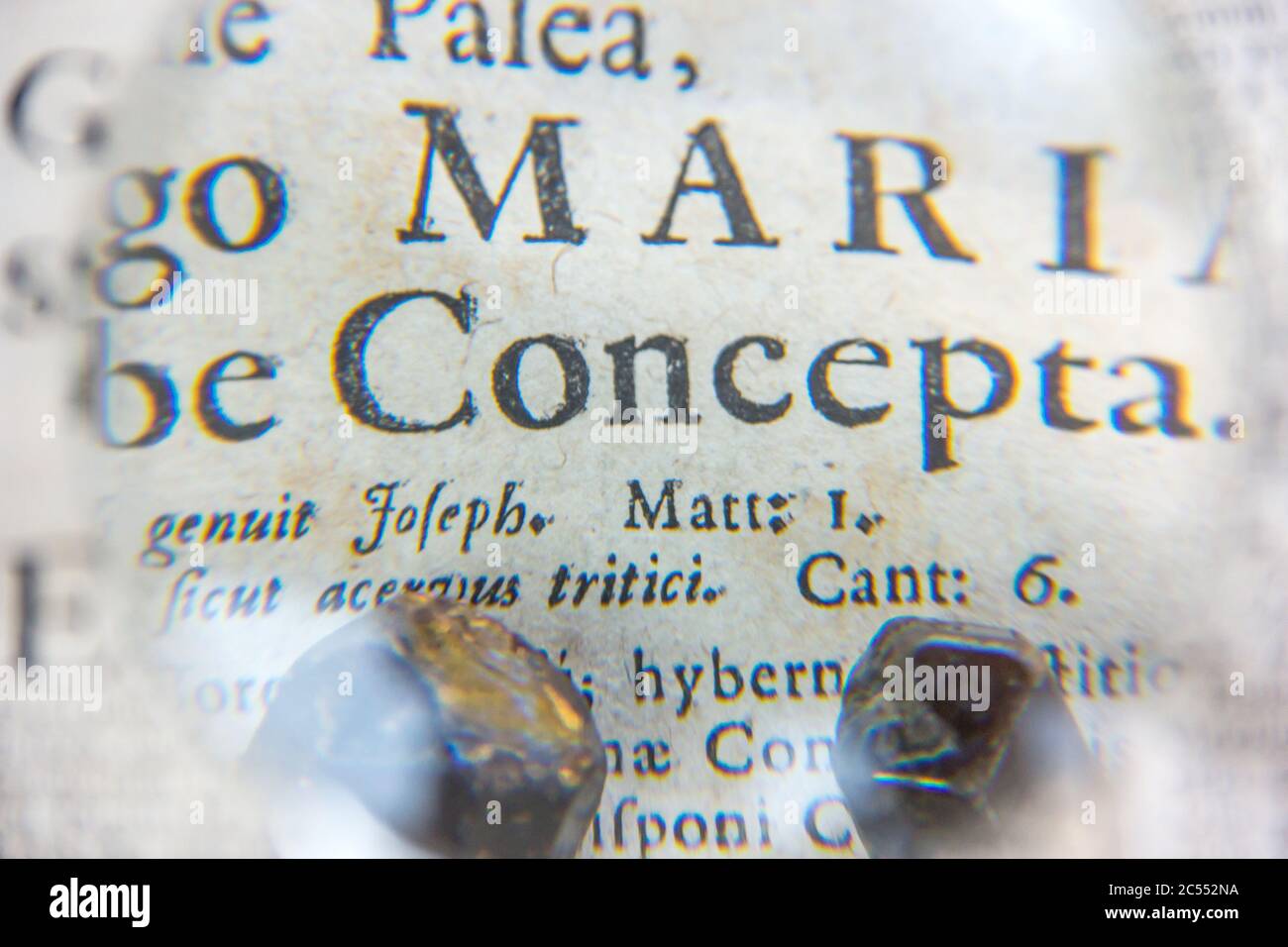 Closeup shot of a page in the Holy Bible under a magnifying glass Stock ...