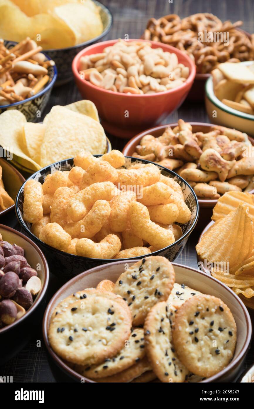 Salty snacks served as party food in ceramic bowls Stock Photo - Alamy