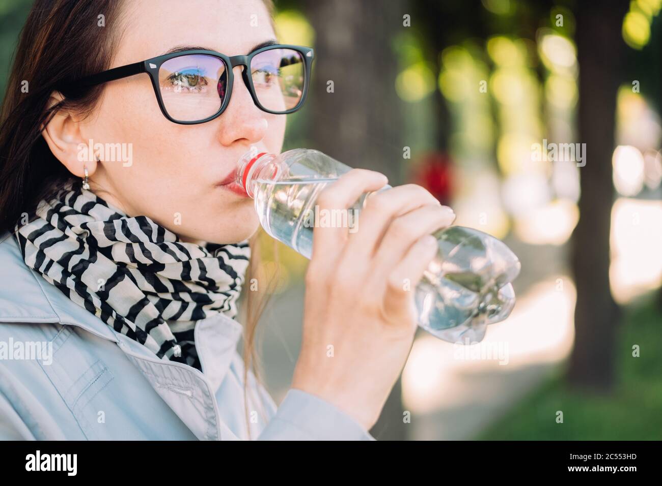 Healthy lifestyle concept - girl drinks water from a plastic bottle Stock Photo - Alamy
