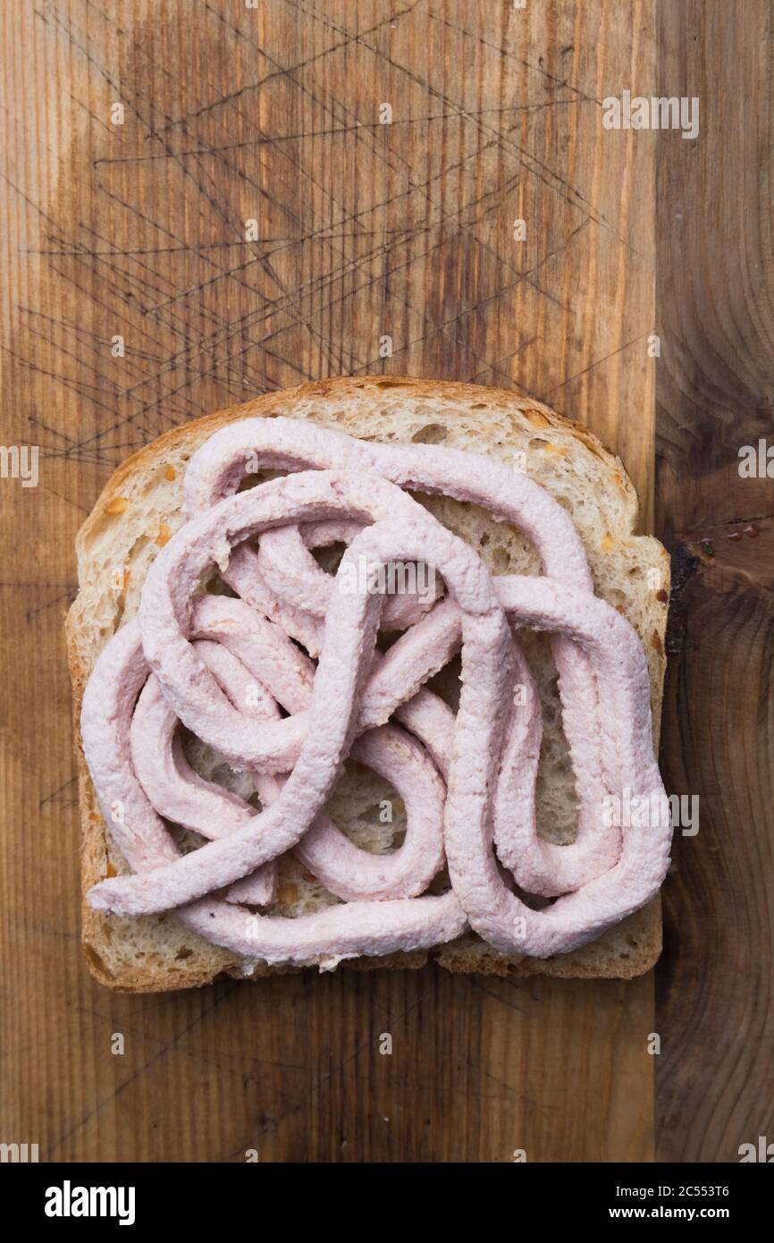 Slice of toast bread with meat pate spread shot from above Stock Photo ...