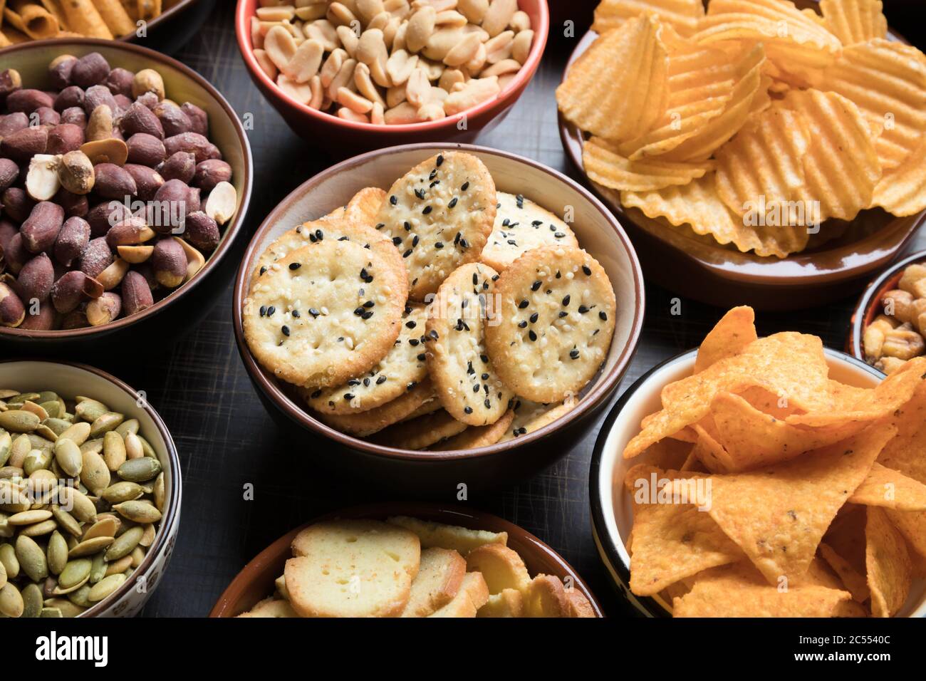 Salty snacks served as party food in ceramic bowls Stock Photo - Alamy