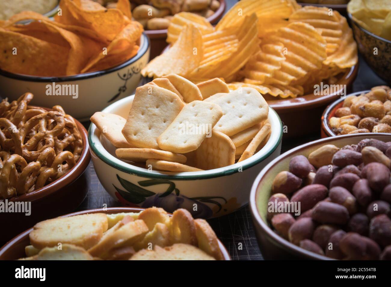 Salty snacks served as party food in ceramic bowls Stock Photo - Alamy
