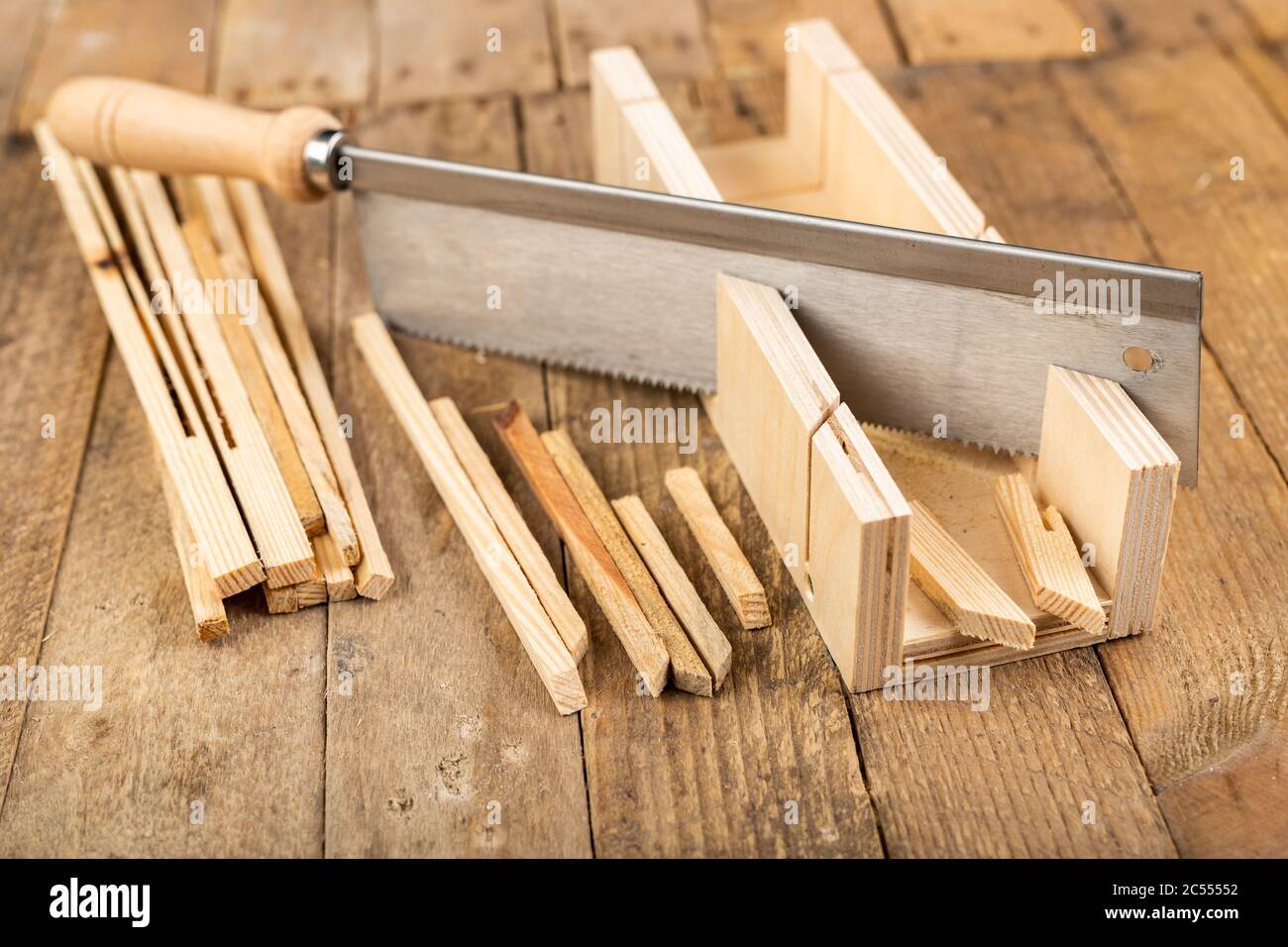 Cutting wooden slats at an angle. Small works in the carpentry shop ...