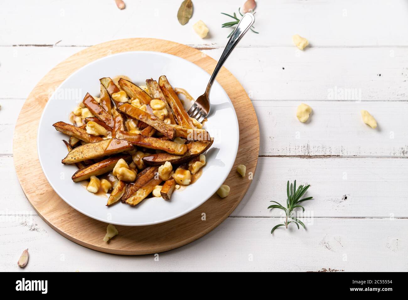 Fast food poutine with fork dug in. A classic fast food cuisine dish ...