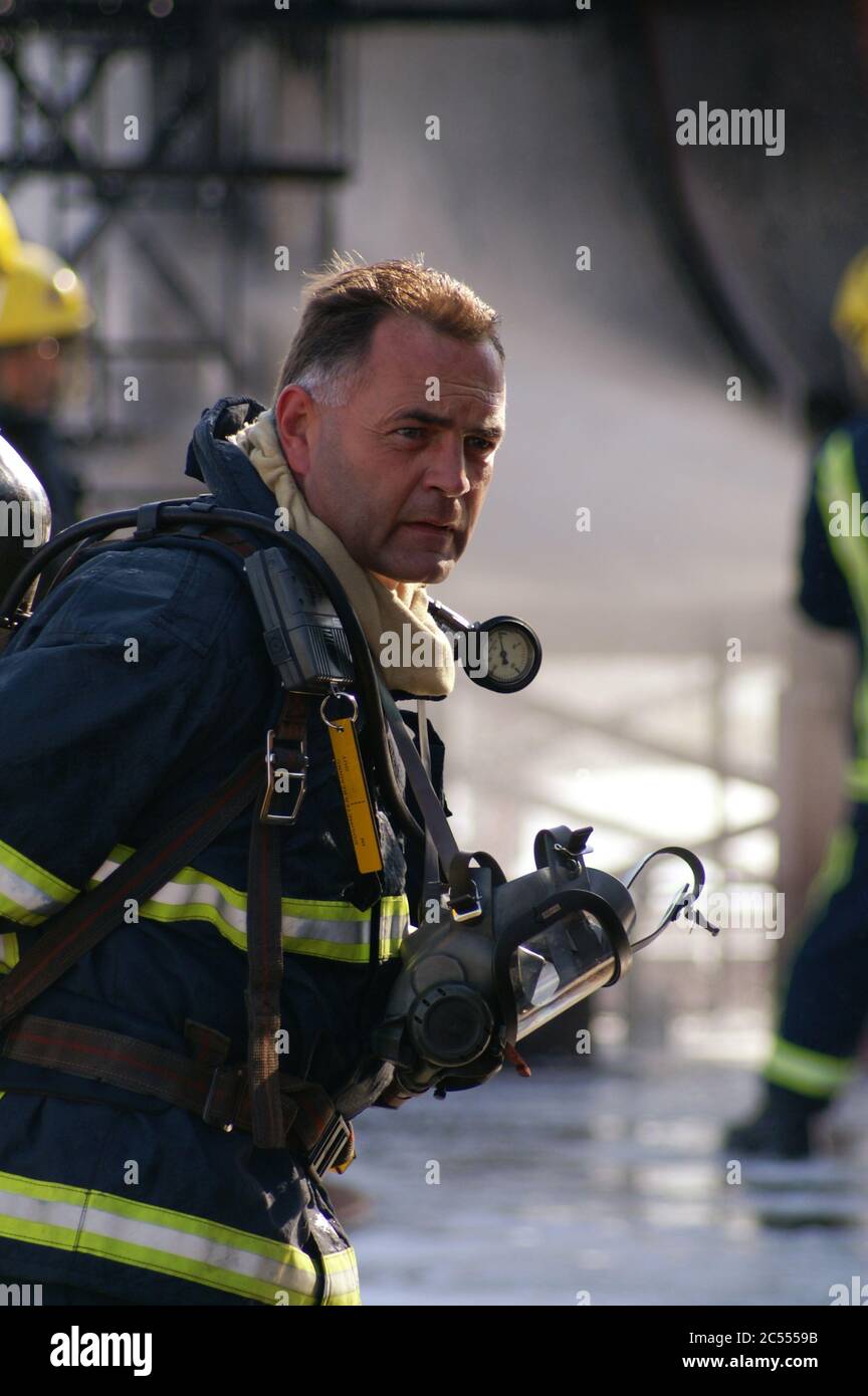 Fire-fighter at blaze Stock Photo - Alamy