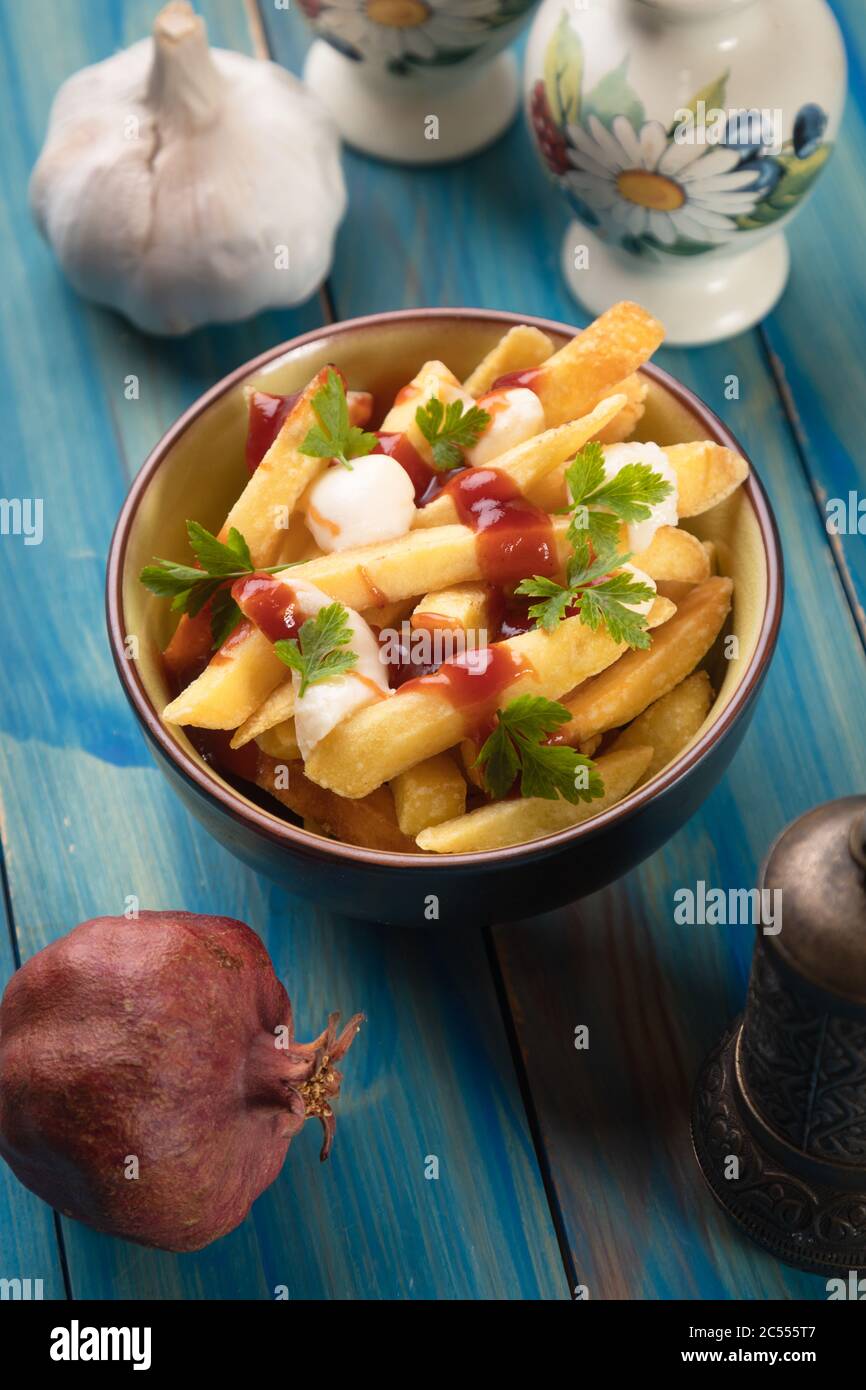 Canadian poutine, fried potato chips with cheese and gravy or sauce ...