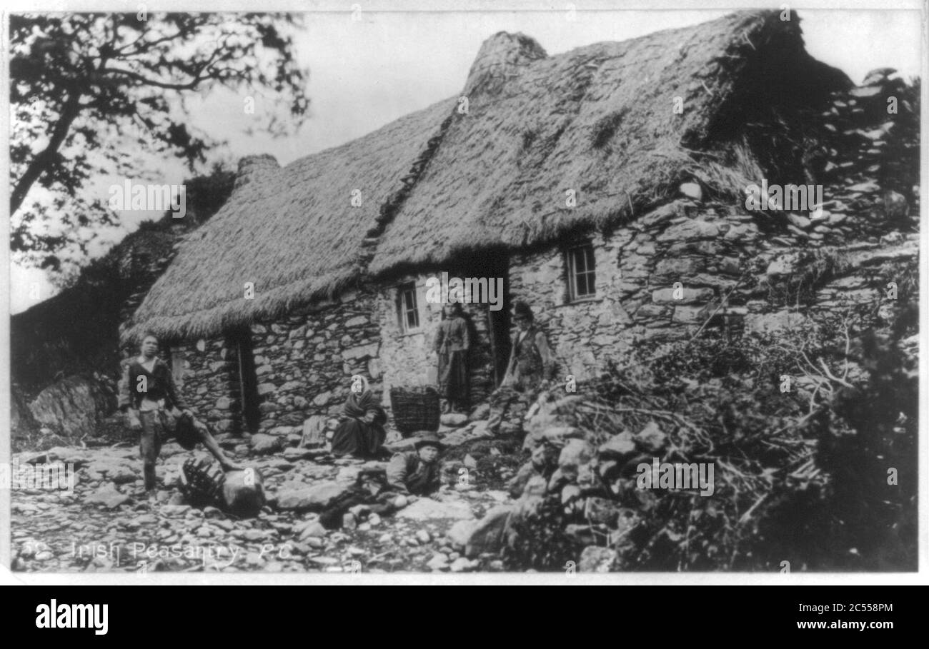 Irish family in front of peasant house with thatched roof, Ireland ...