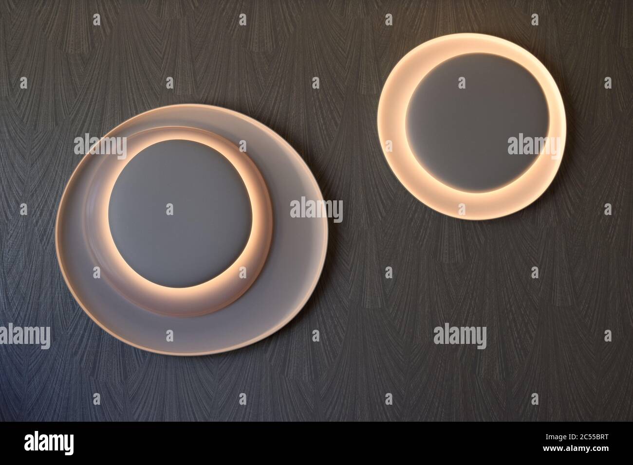 Two different size round modern contemporary mood lights hanging on a ...