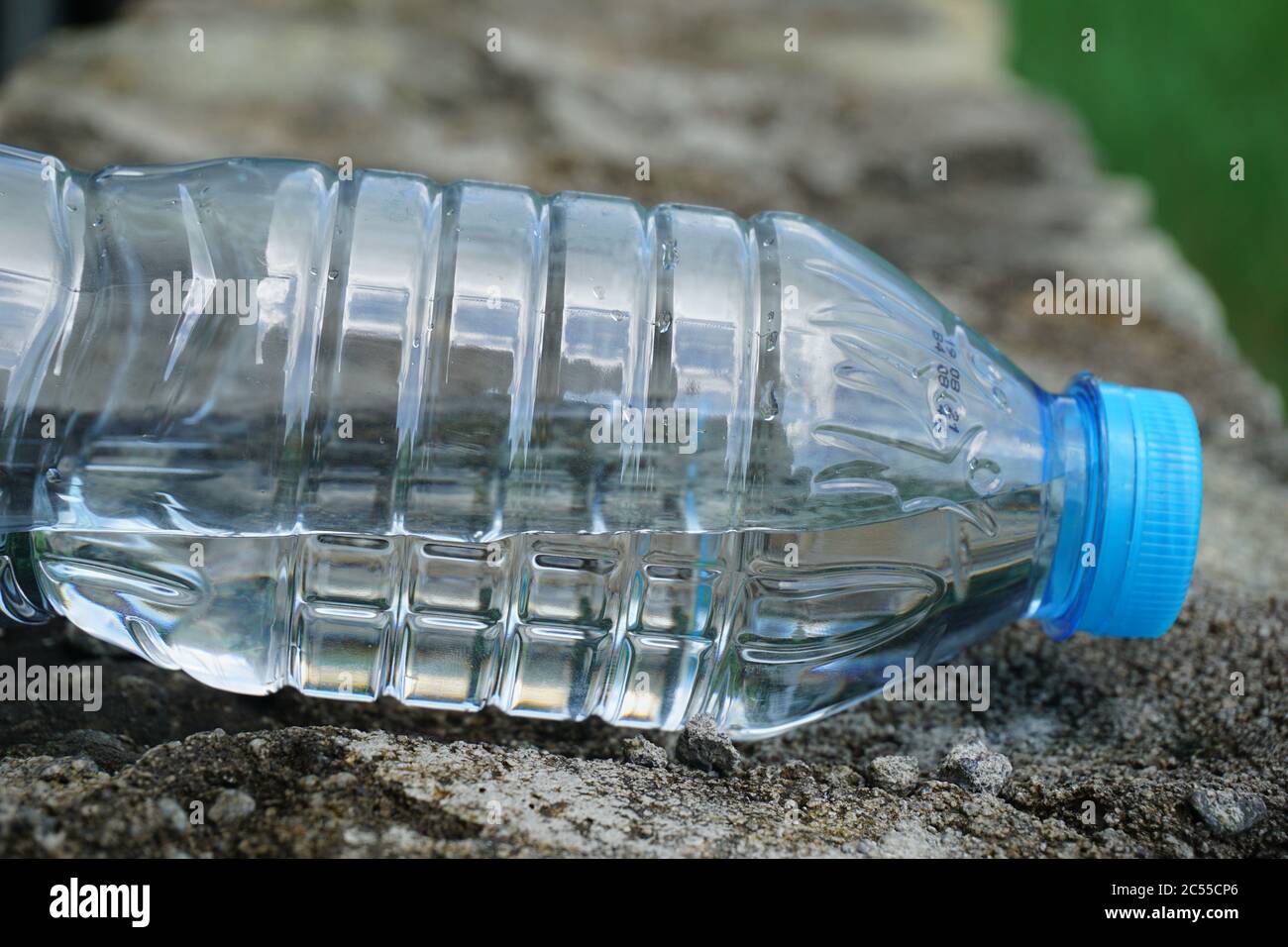 Selective focus shot of a half-empty water bottle on a surface captured ...