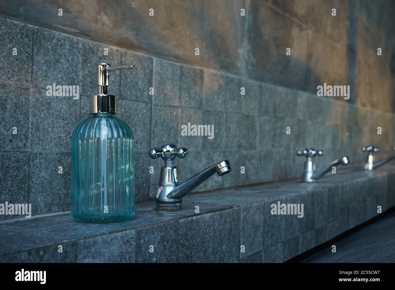 High angle shot of an empty soap container by the water tap captured in ...