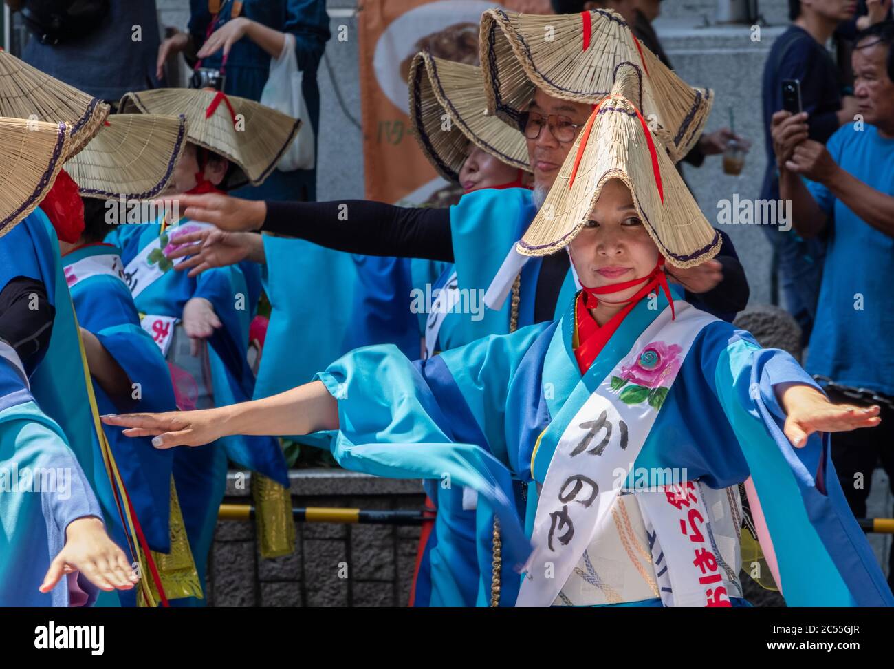 Folk dancers in colorful yukata and amigasa straw hat dancing in ...