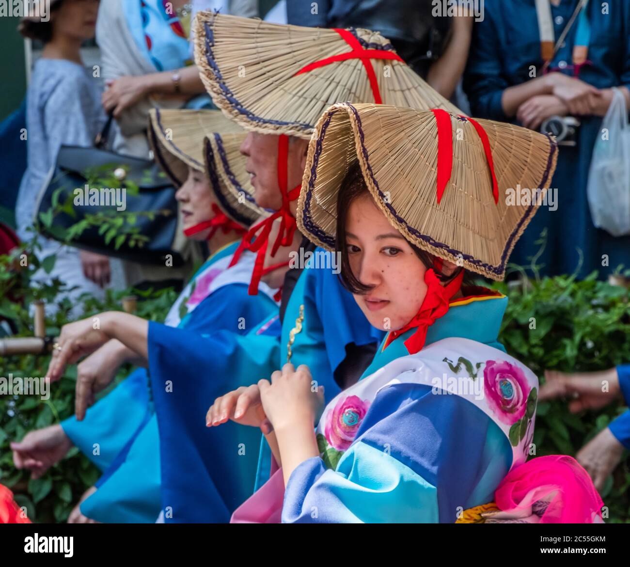 Folk dancers in colorful yukata and amigasa straw hat dancing in ...