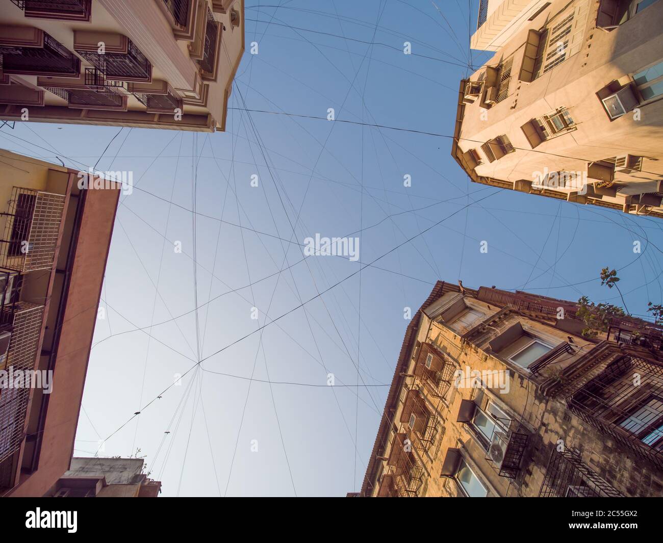 Electric wires hanging on the buildings in Mumbai Stock Photo - Alamy
