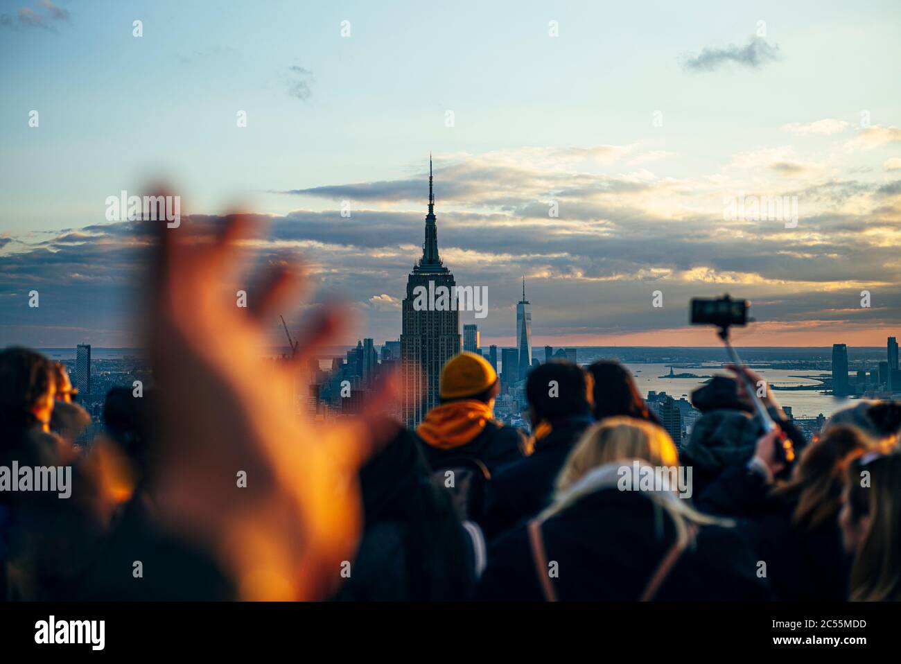 People watch from skyscrapers the buildings of New York at sunset and ...