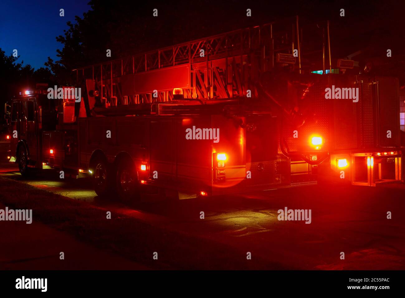 Flashing emergency lights of red fire truck at dusk the city Stock ...