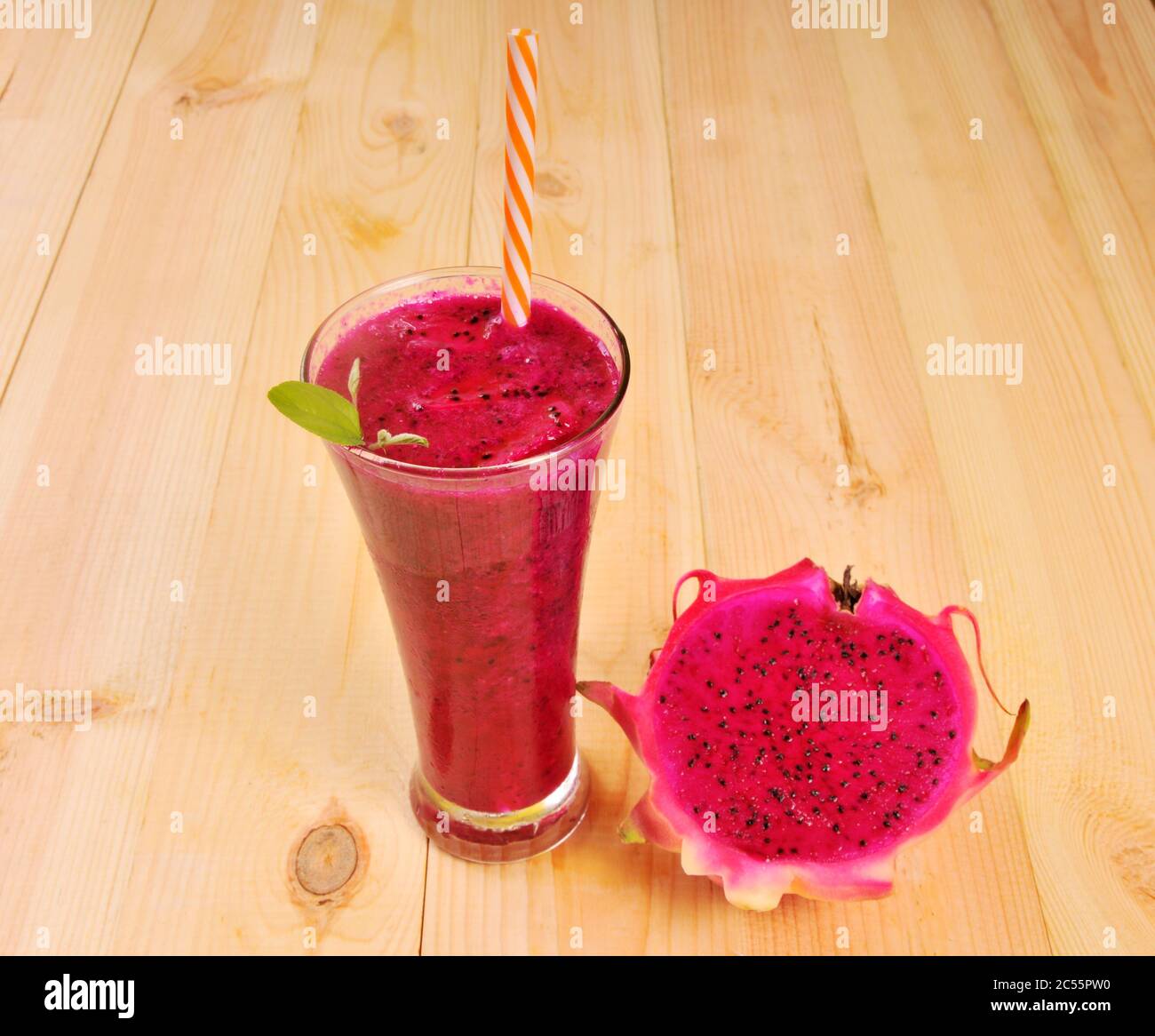 Red dragon fruit smoothies in glasses with half sliced. Pitahaya fruit ...