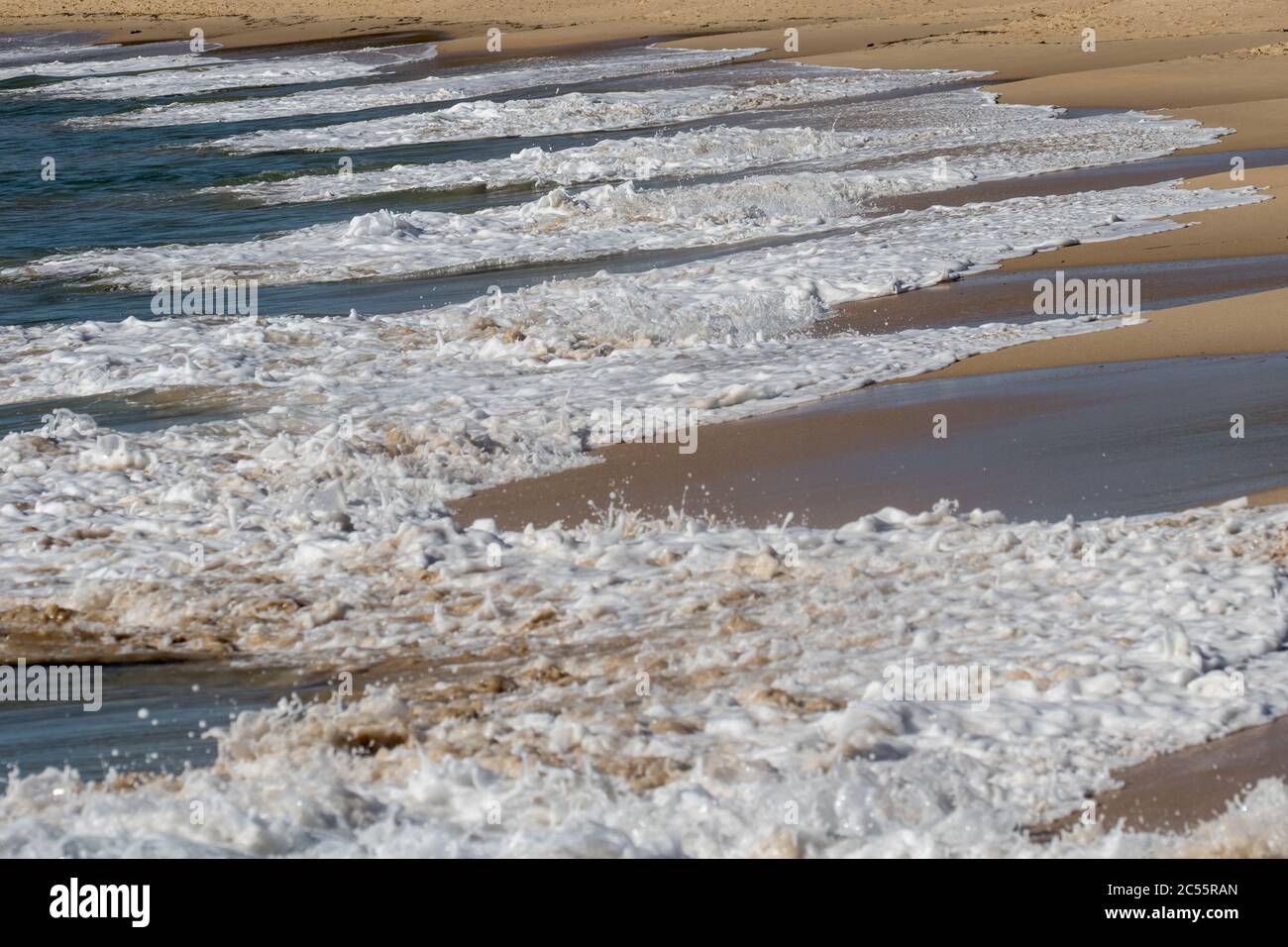Waves washing up onto beach Stock Photo - Alamy