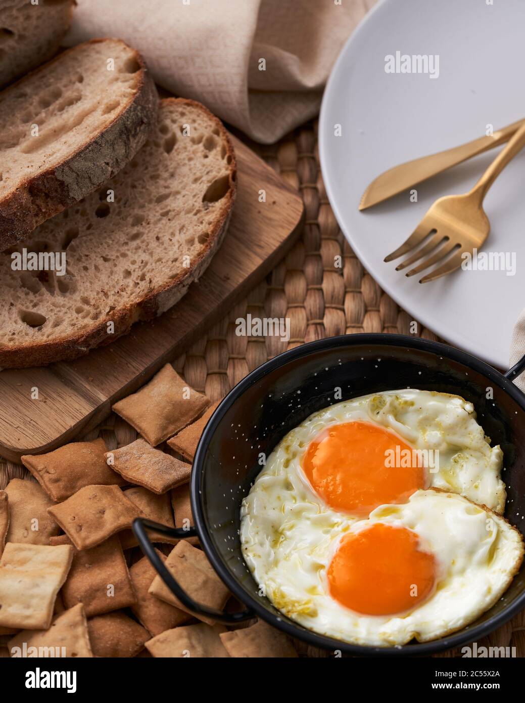Vertical picture of an English breakfast with fried eggs and black ...
