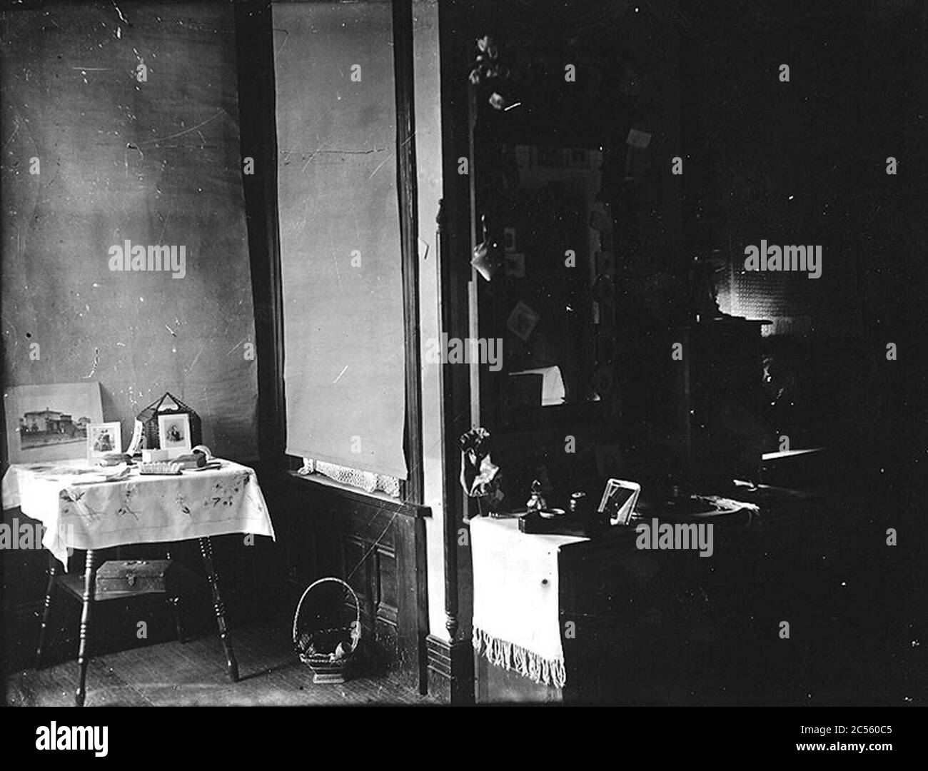 Interior scene showing tables with various personal objects probably ...