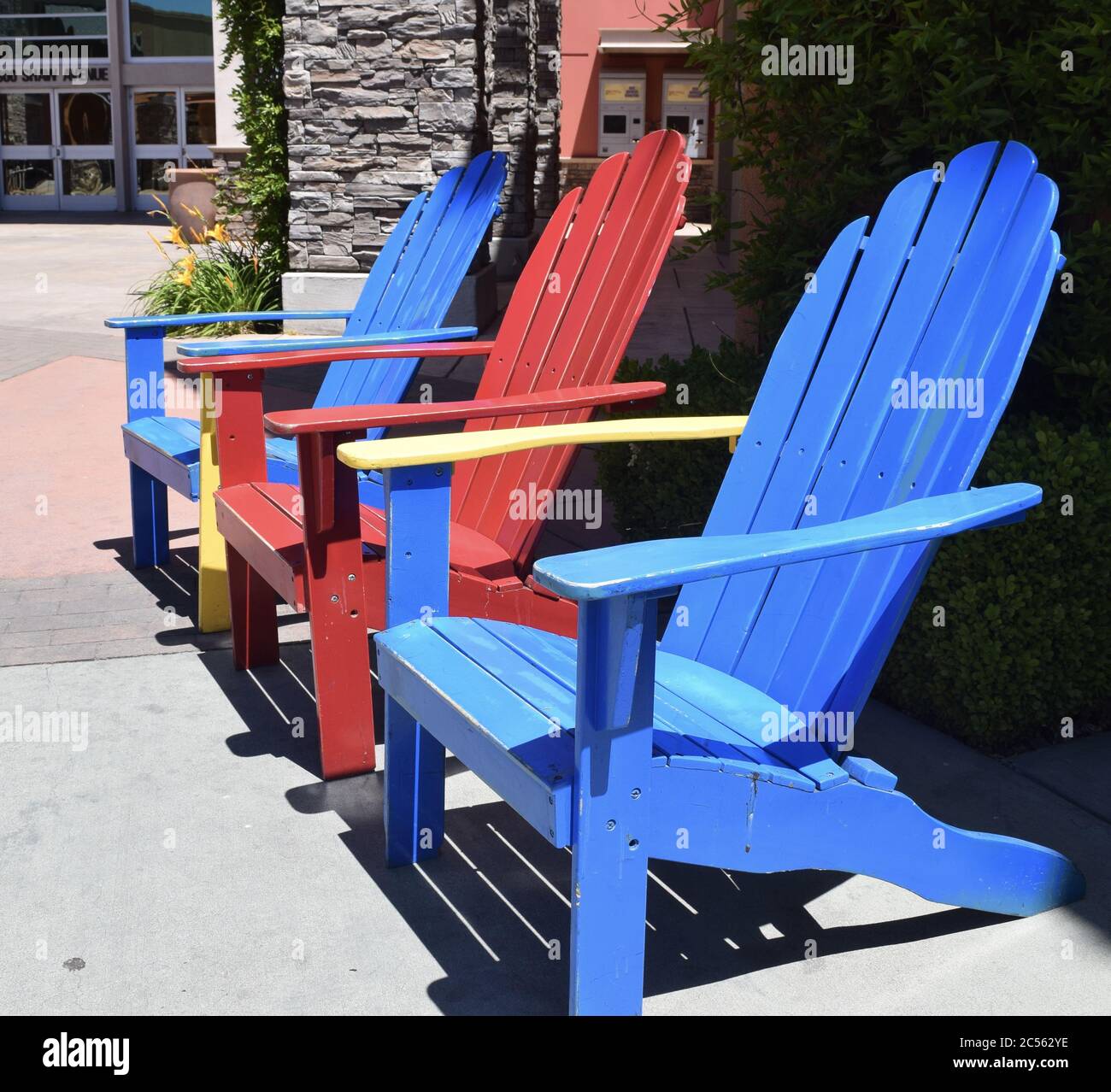 Wooden blue and red colored chairs Stock Photo - Alamy