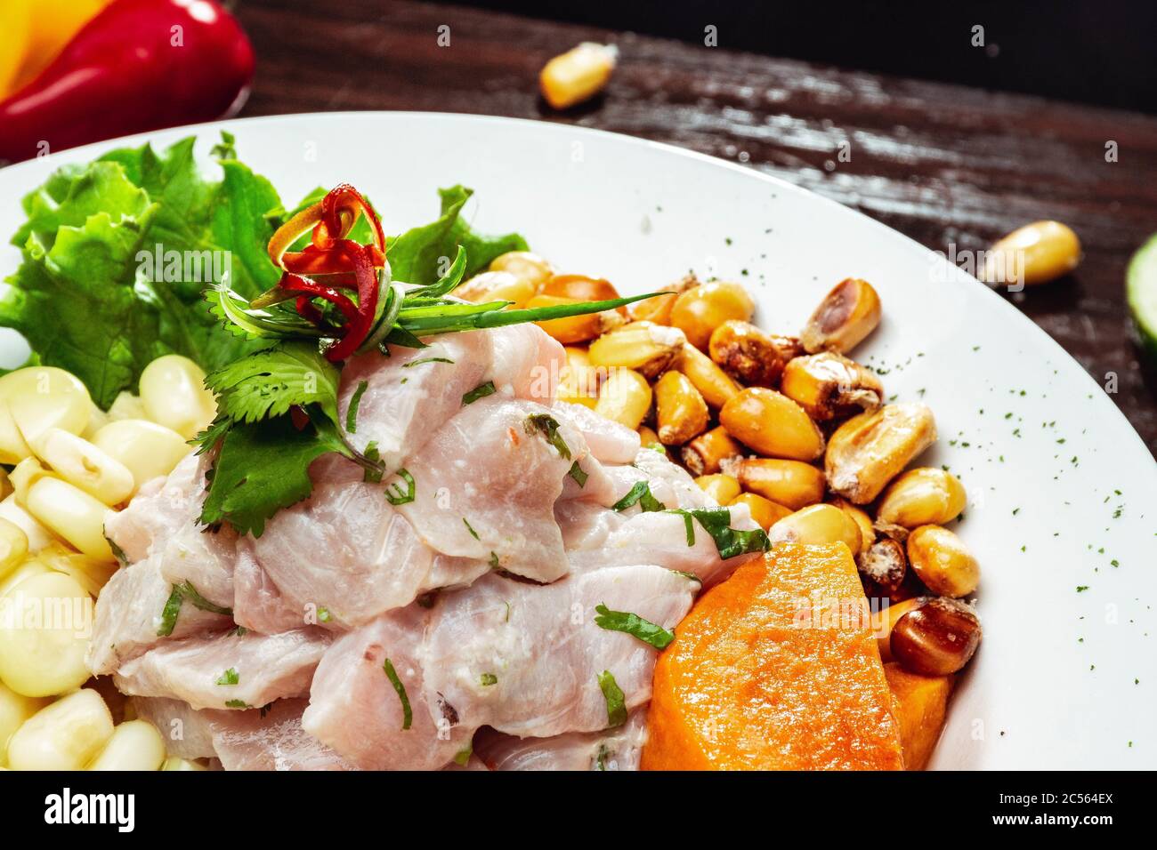 Delicious Peruvian ceviche in a white plate Stock Photo - Alamy