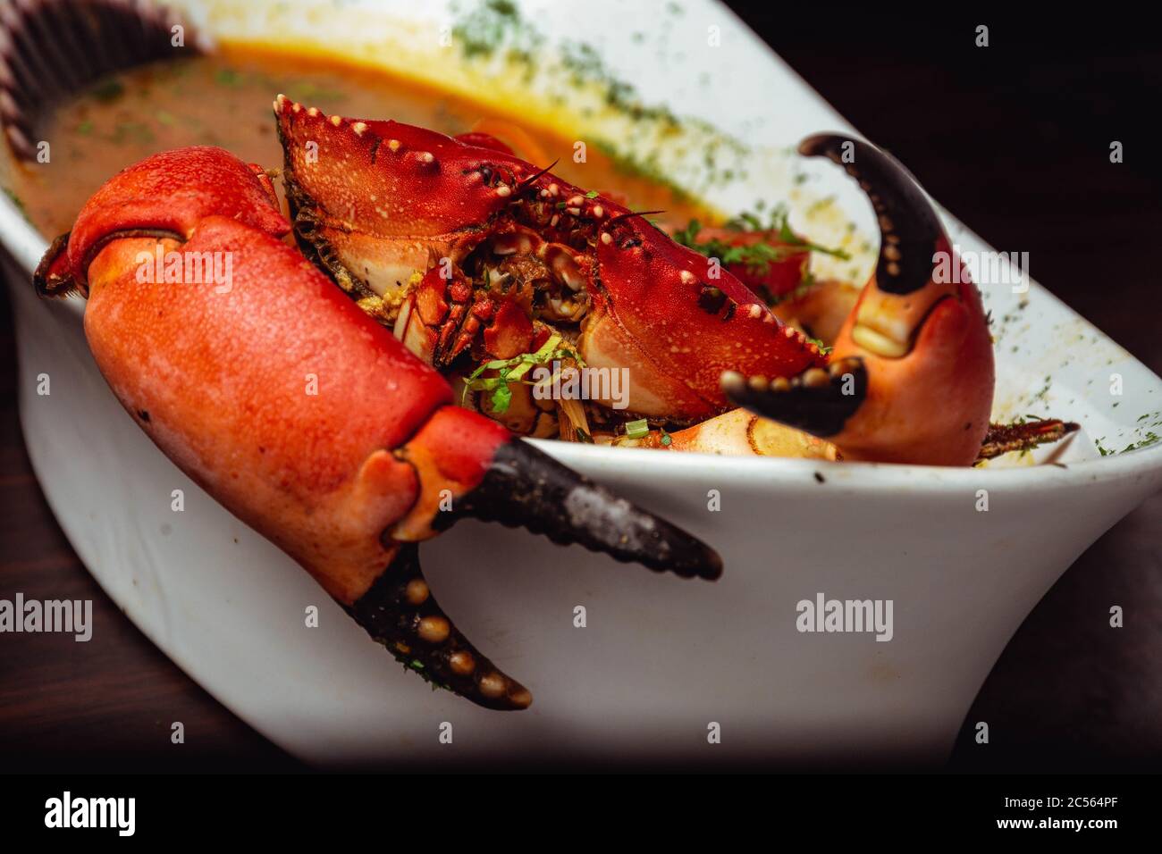 Whole crab in a bowl of a seafood soup Stock Photo - Alamy
