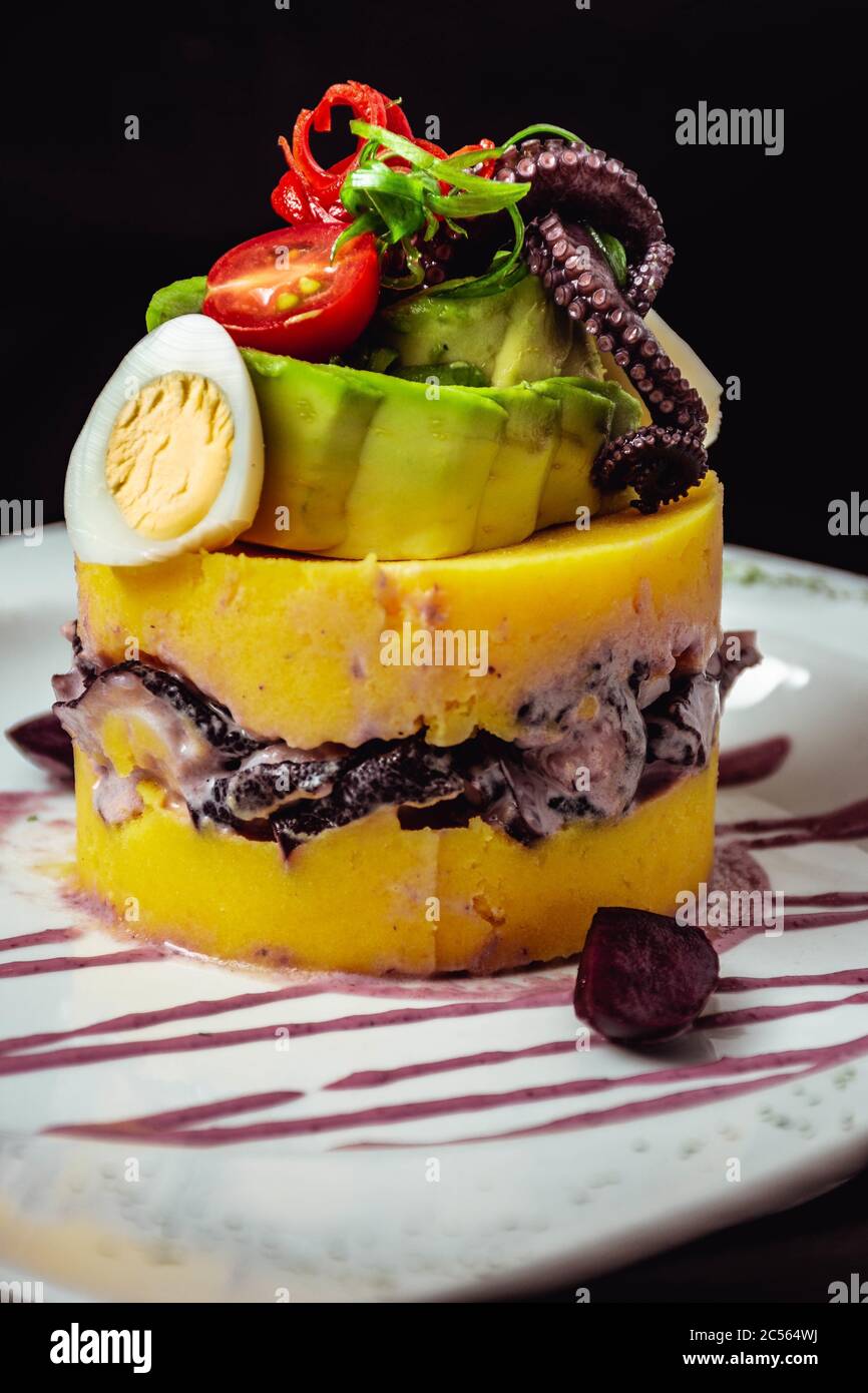 Dish with potatoes, octopus tentacles, avocados, and vegetables Stock ...