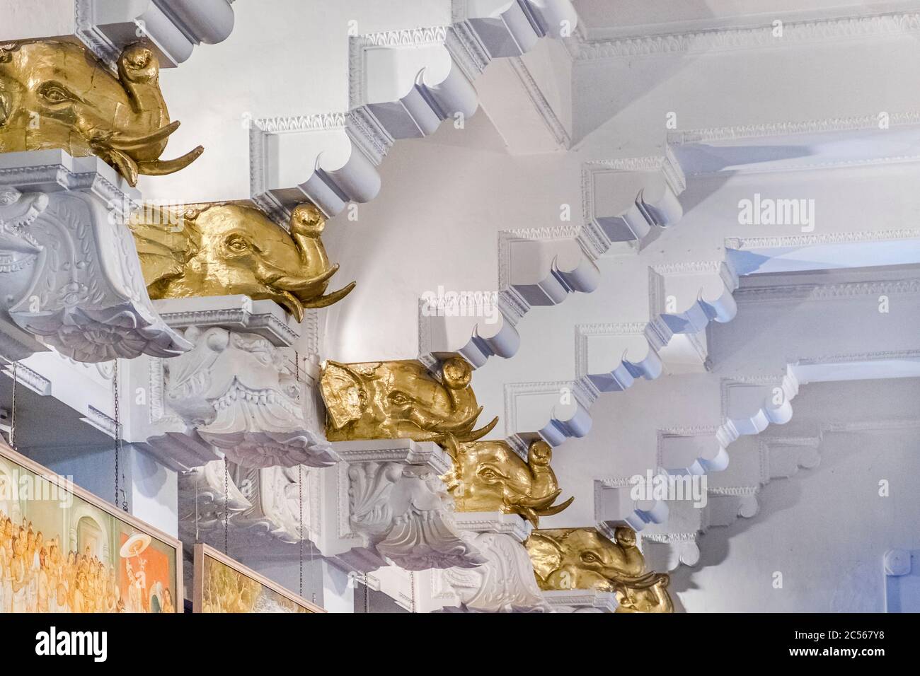 The ceiling and walls of a corridor decorated with golden elephants ...