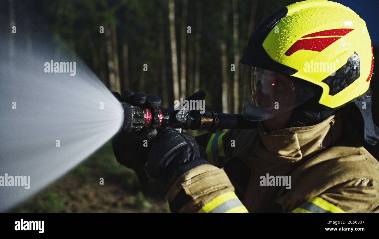 Fireman holding water hose hi-res stock photography and images - Alamy