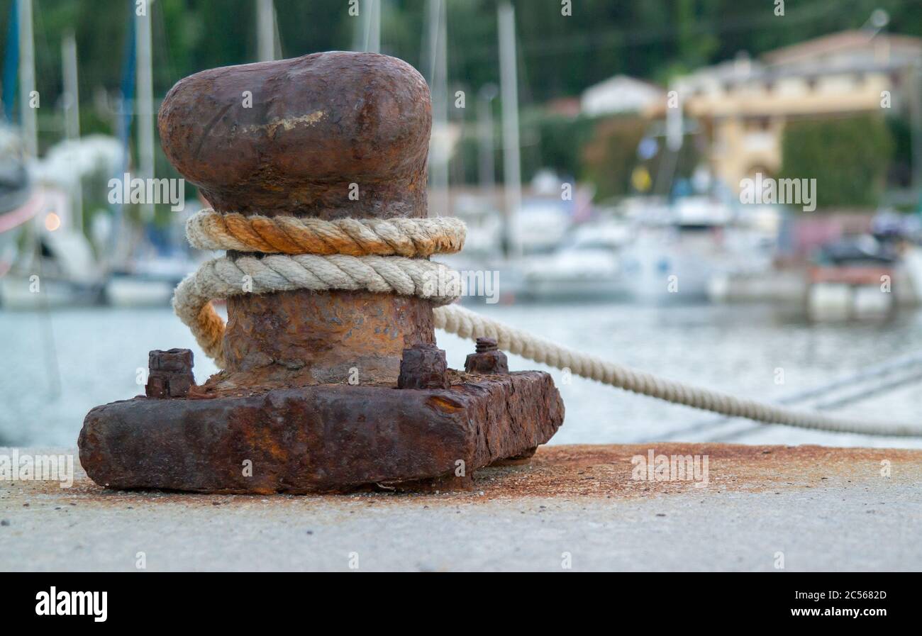 Ropes of a ship wrapped around a mooring bollard on the pier Stock ...