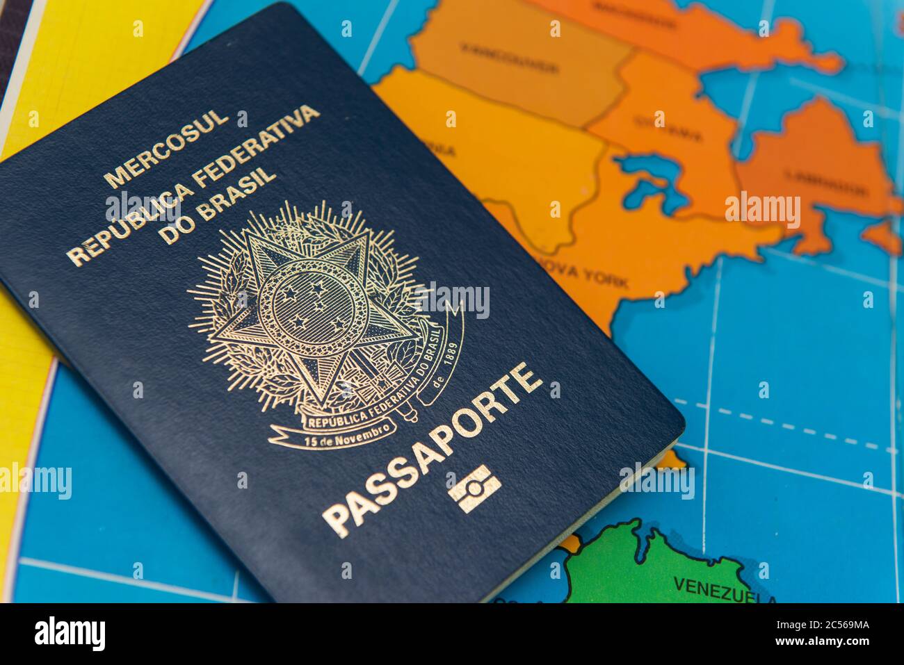 Top view of Brazilian passport over map. Focus on the North American ...
