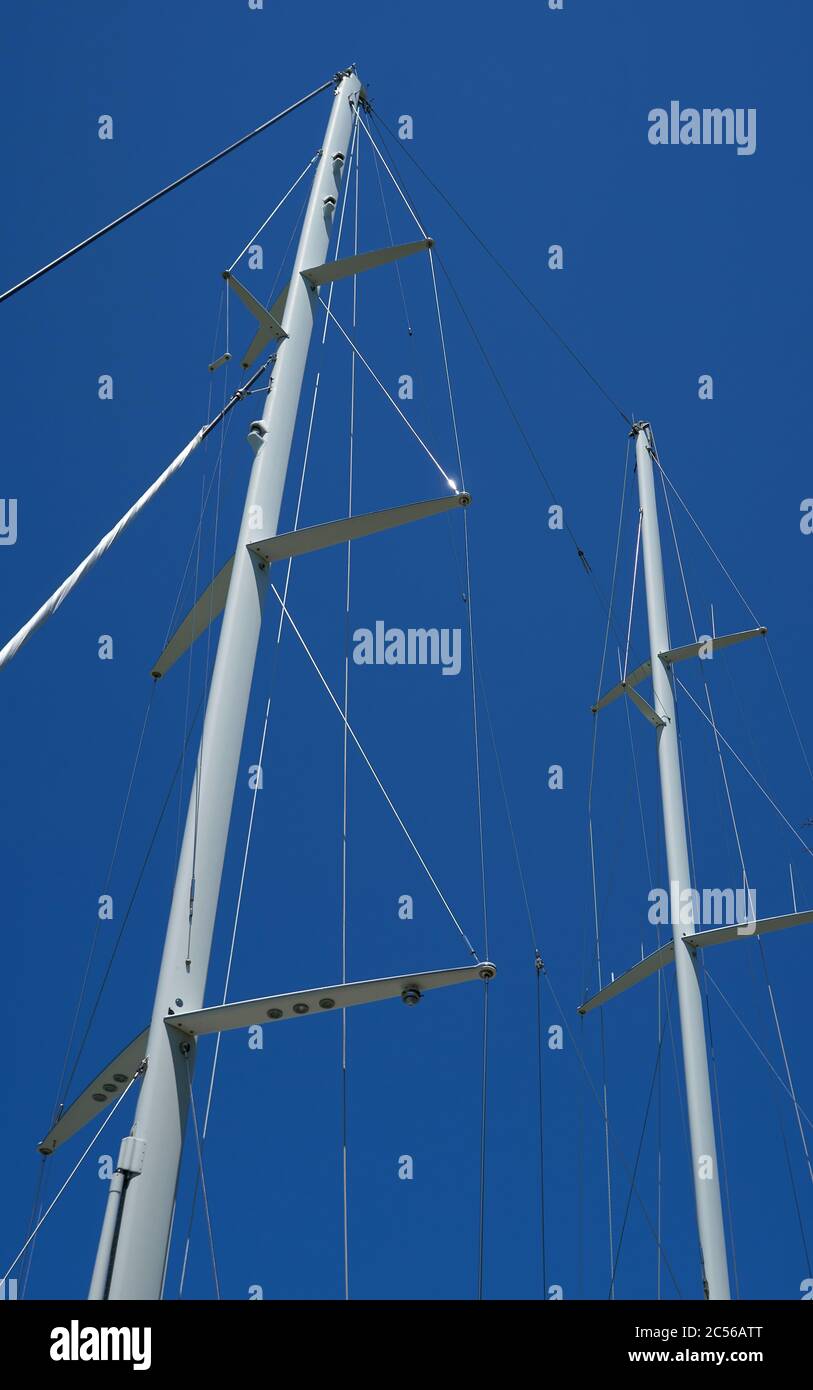 Abstract photo of the white twin masts of a luxury sailing ship against ...