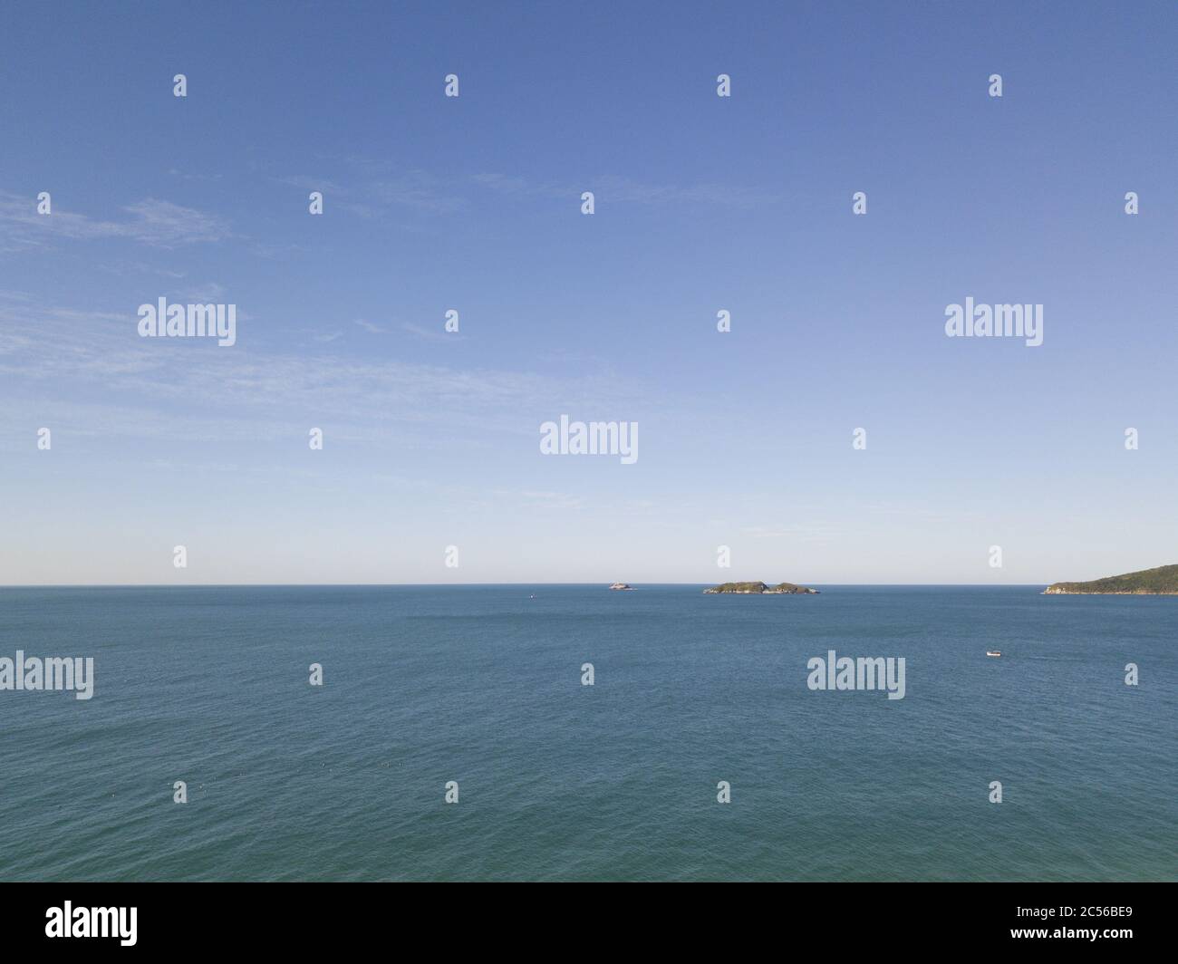 Pure blue sea under the clam sky Stock Photo - Alamy