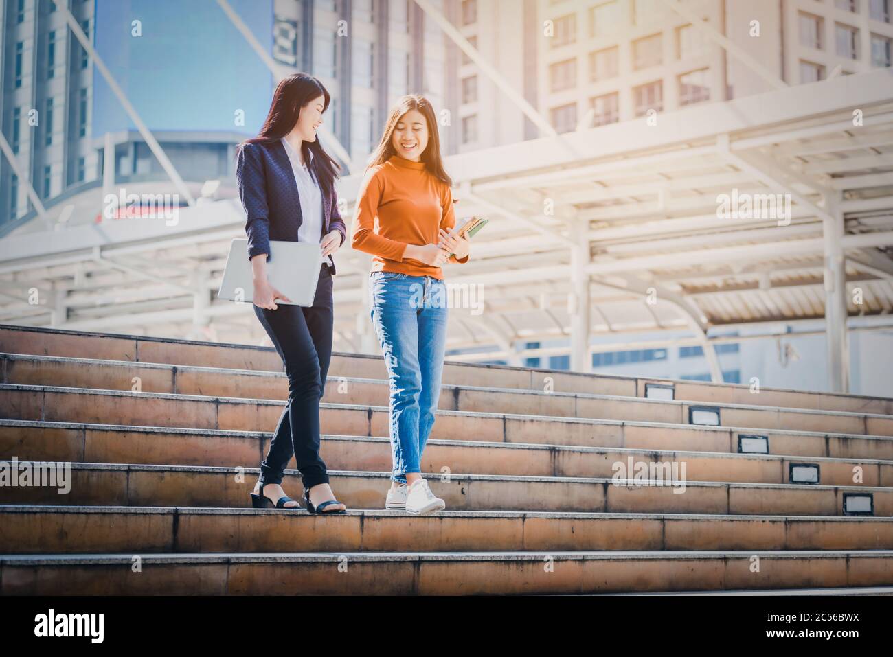 Diversity Teenagers holding laptop computer and climbing stairs go to ...