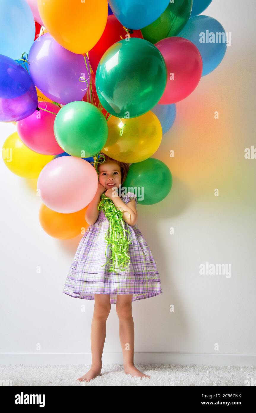 little girl holding color balloons Stock Photo - Alamy