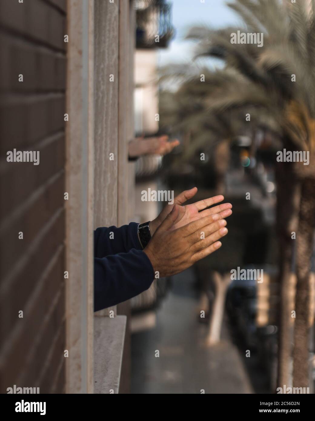 Hands out of windows clapping Stock Photo - Alamy