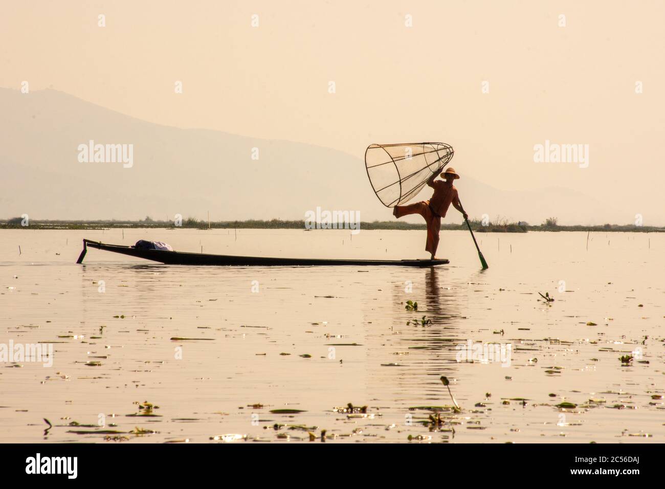 local man balancing himself on the boat Stock Photo - Alamy
