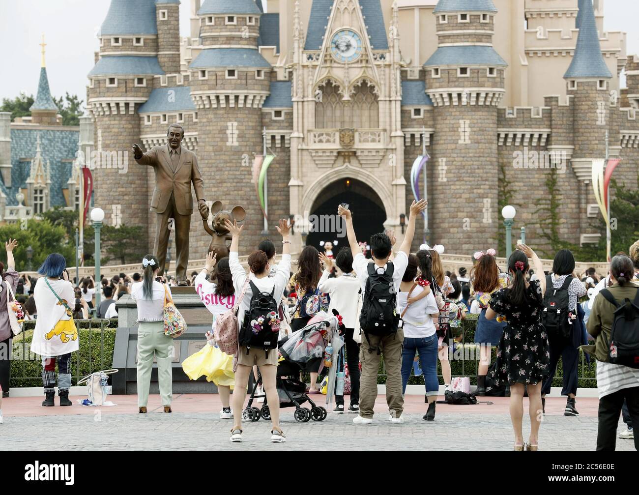 Tokyo Disneyland, Japan. 1st July 2020. Visitors wave as Mickey Mouse ...