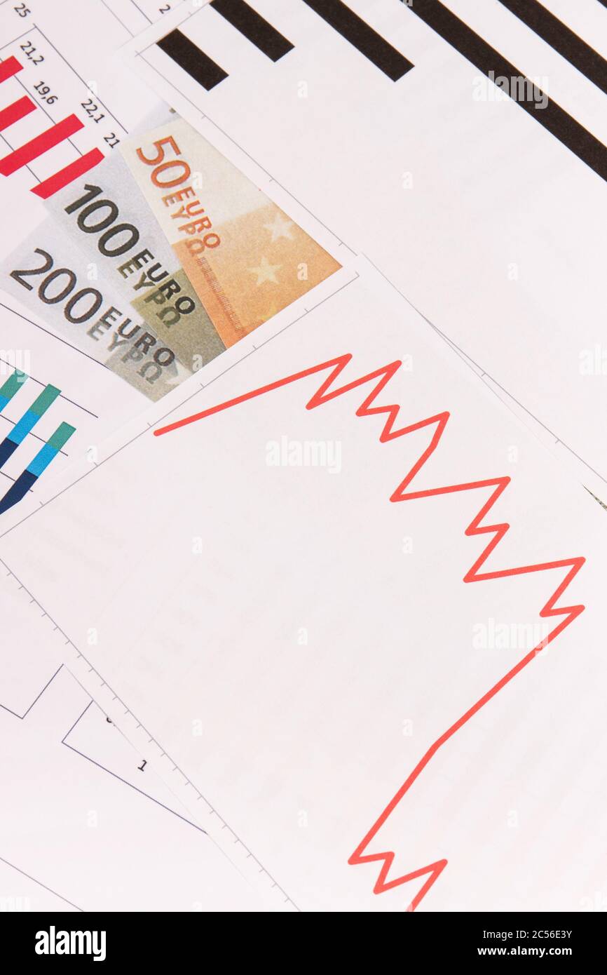 Currencies euro and downward graphs representing financial crisis ...